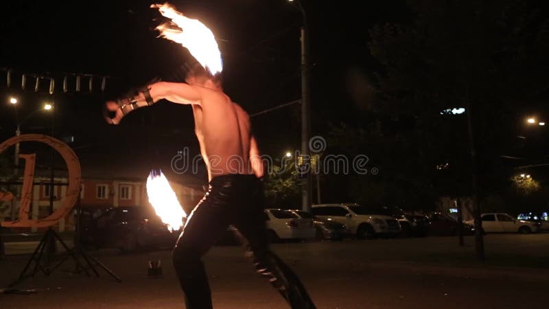 An Amazing Fire Show at Night. a Woman Spinning Fire. Back View of ...