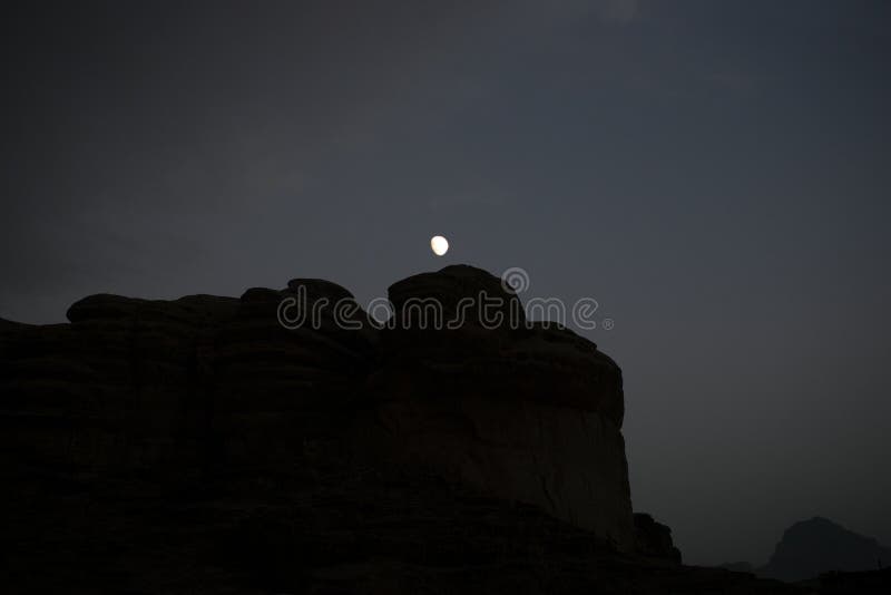 An Amazing Moon Rises Above the Mountain Cliffs in a Beautiful Dark Sky ...