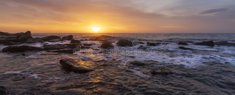 Panoramic View. Sunset Over the Sea with Rocky Coast Stock Photo ...
