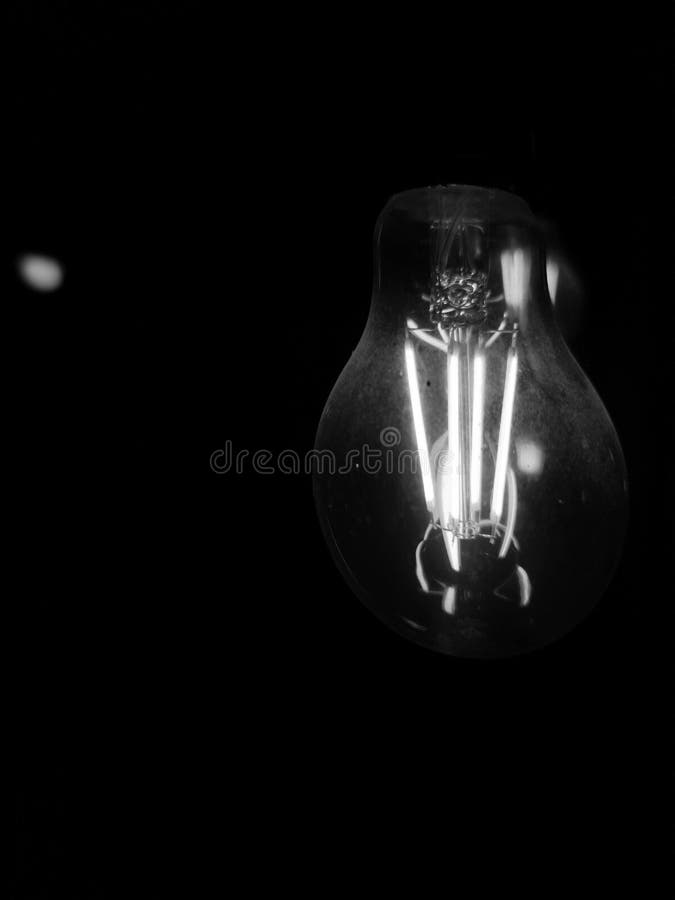 Electricity Current Inside a Retro Crystal Clear Light Bulb. Stock ...