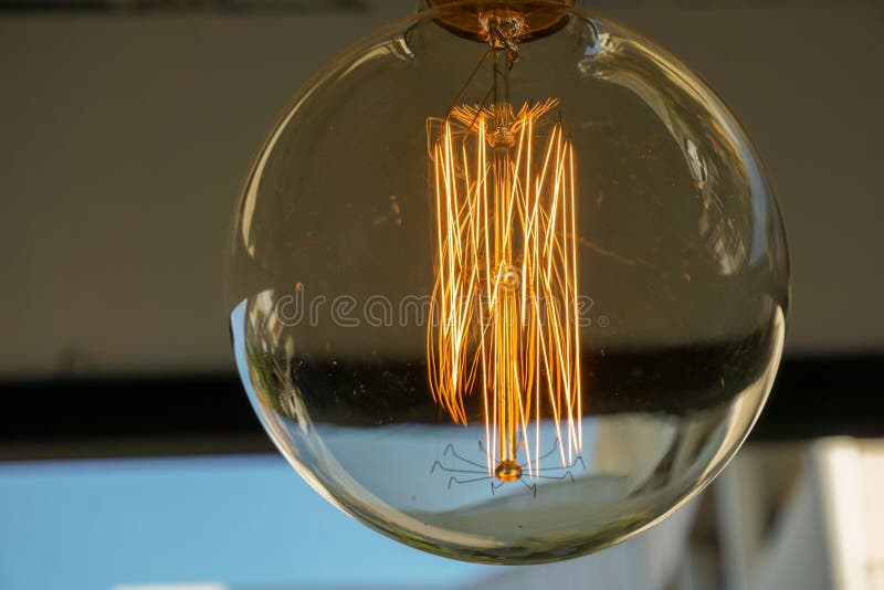 Electricity Current Inside a Retro Crystal Clear Light Bulb. Stock ...