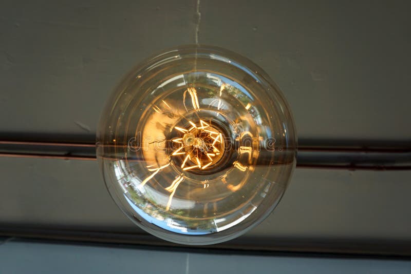 Electricity Current Inside a Retro Crystal Clear Light Bulb. Stock ...