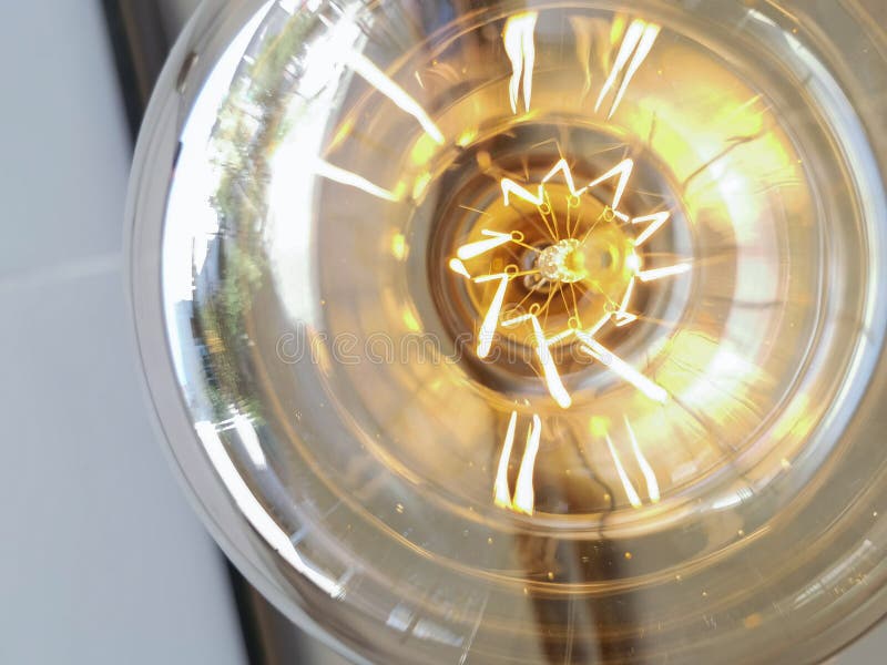 Electricity Current Inside a Retro Crystal Clear Light Bulb. Stock ...