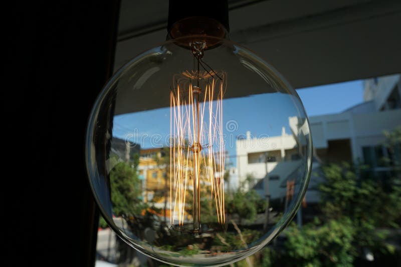 Electricity Current Inside a Retro Crystal Clear Light Bulb. Stock ...