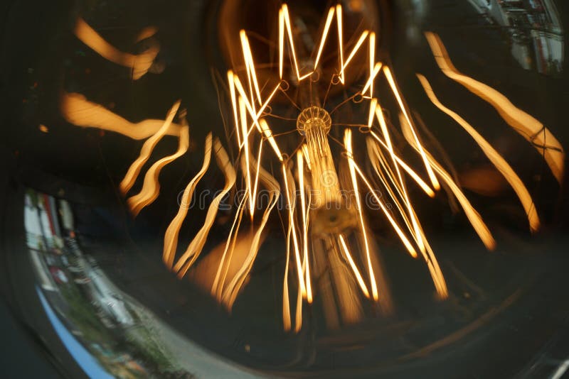 Electricity Current Inside a Retro Crystal Clear Light Bulb. Stock ...