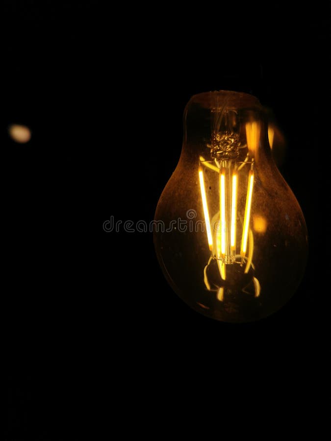 Electricity Current Inside a Retro Crystal Clear Light Bulb. Stock ...