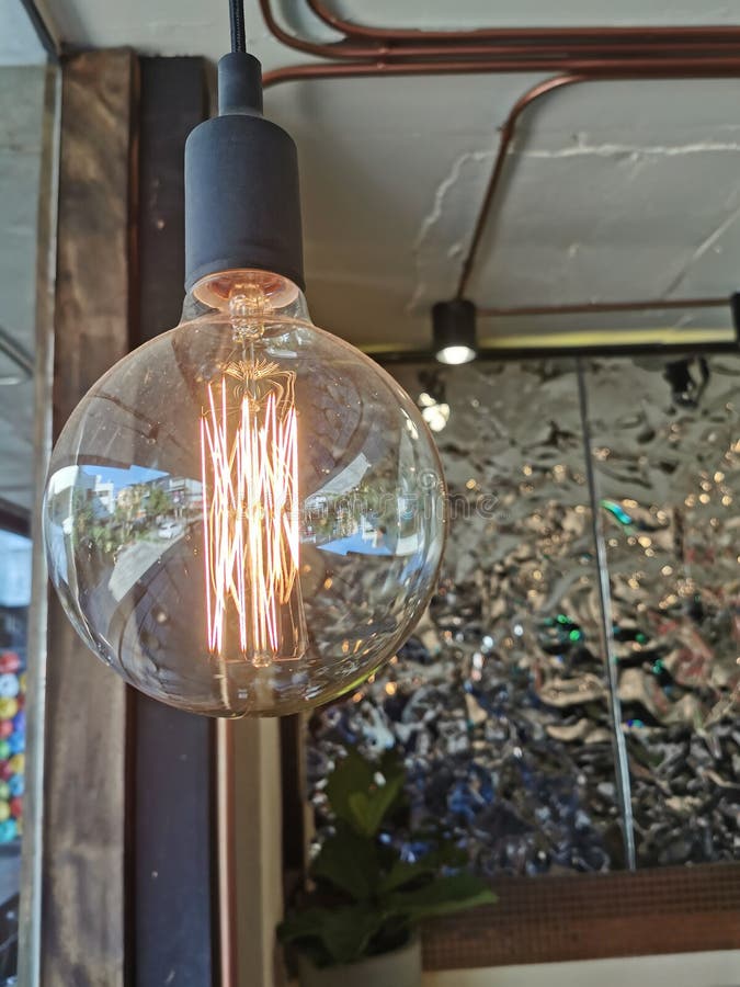 Electricity Current Inside a Retro Crystal Clear Light Bulb. Stock ...