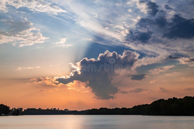 Amazing Sunset at the Lake with Sun Rays in Clouds Stock Image - Image ...