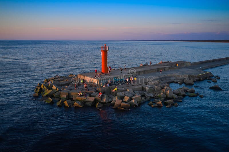 Amazing Sunset Sky and Long Stone Pier with Lighthouse Stock Image ...