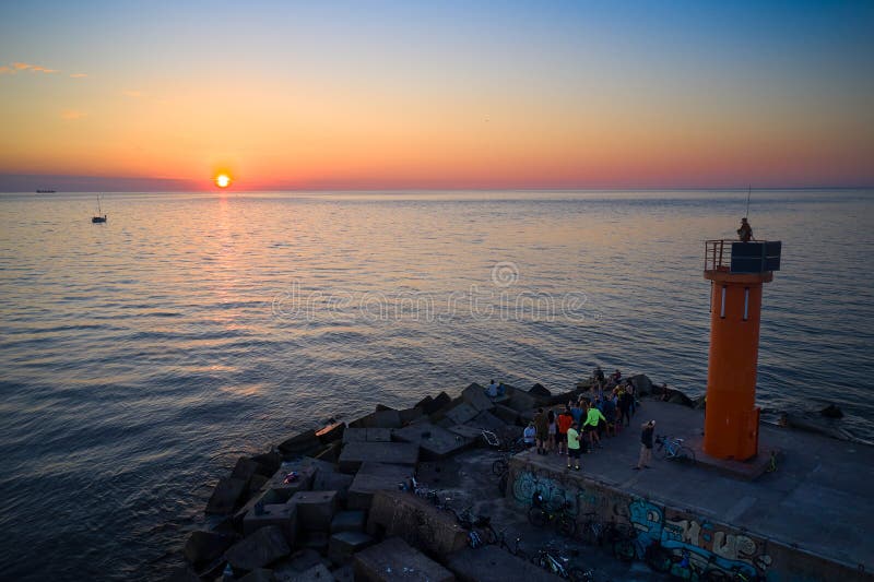 Amazing Sunset Sky and Long Stone Pier with Lighthouse Editorial Stock ...