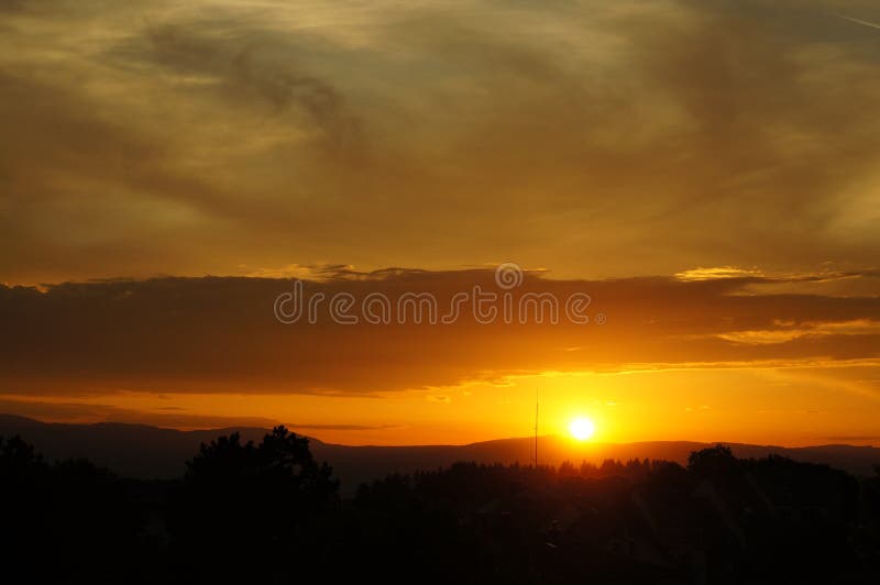 An Amazing Sunset Under a Cloudy Sky Stock Image - Image of shadows ...