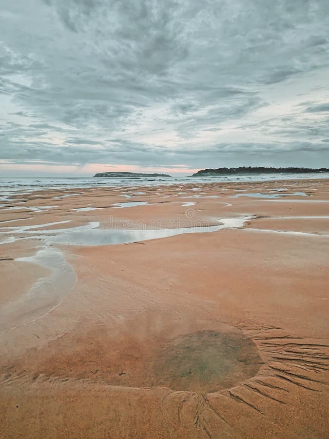 Amazing Vertical Shot of a Mudflat in Cloudy Weather during Sunrise ...