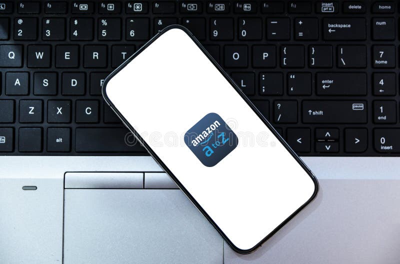 Amazon Application on Smartphone Screen Concept with Laptop Keyboard in ...