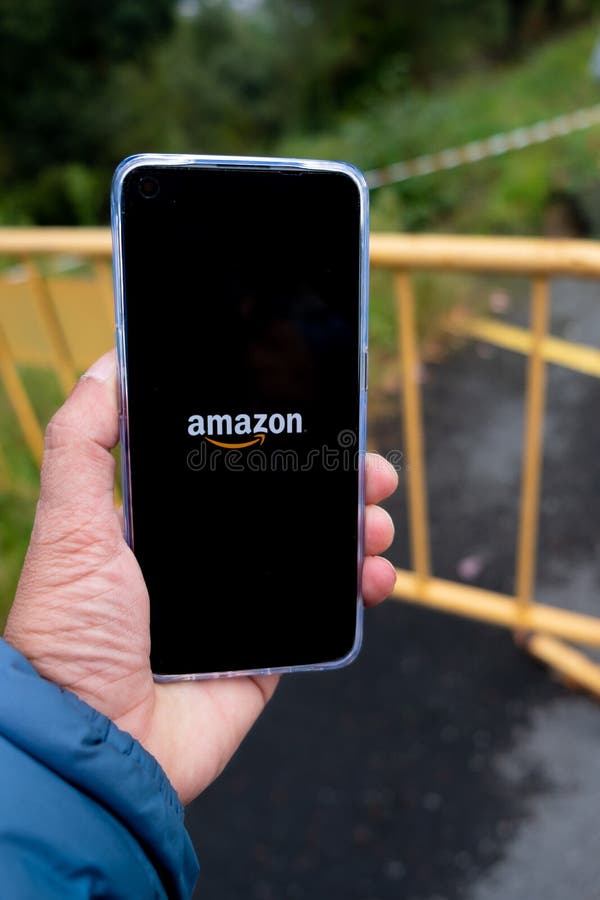 Hand Holding Mobile Phone with Amazon Logo on the Screen Editorial ...