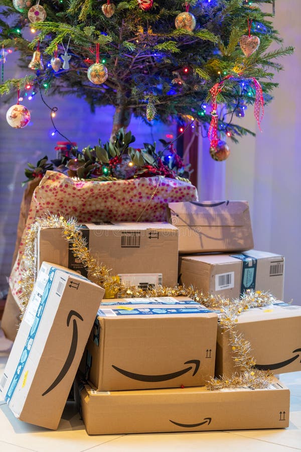 Amazon Packages Deposited in Front of the Christmas Tree Editorial ...