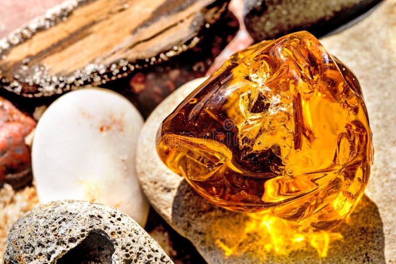 Amber on a beach stock photo. Image of precious, geology - 93667842