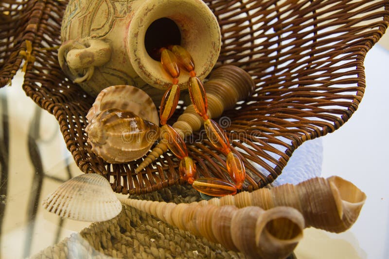 Amber Beads Over Clay Vessel and Shells Stock Photo - Image of closeup ...