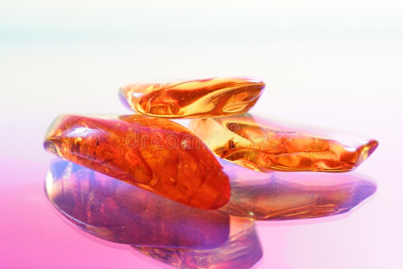 Amber Gemstone on Pink and Blue Background. Shallow Stock Image - Image ...