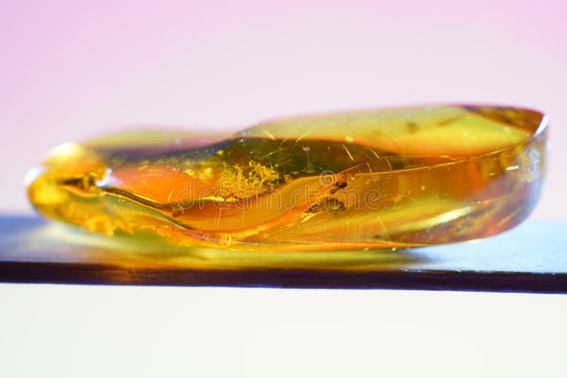 Amber Gemstone on Pink and Blue Background. Shallow Stock Photo - Image ...