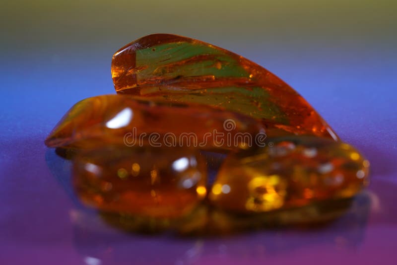 Amber Gemstone on Pink and Blue Background. Shallow Stock Image - Image ...