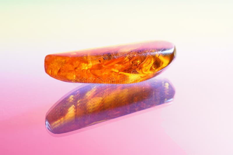 Amber Gemstone on Pink and Blue Background. Shallow Depth a Field Stock ...