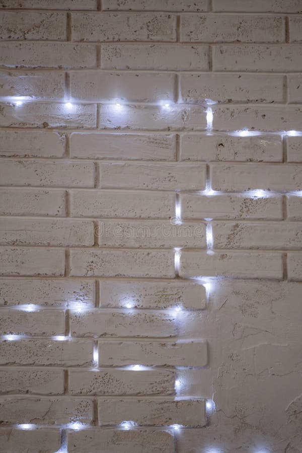 Ambient White String Lights Adorning a Rustic Brick Wall Stock Image ...