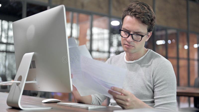 Ambitious Guy Reading Document on Office Desk Stock Photo - Image of ...