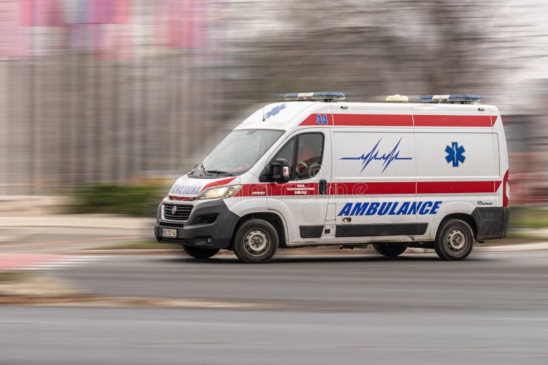 Ambulance in Motion at a City Intersection during an Emergency Response ...