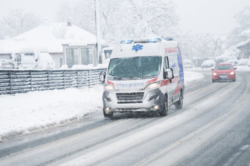 Ambulance on a Snowy Winter Street Stock Photo - Image of emergency ...