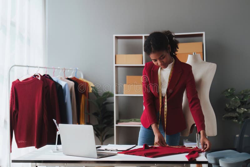 American African Fashion Designer Working in Studio with Laptop ...