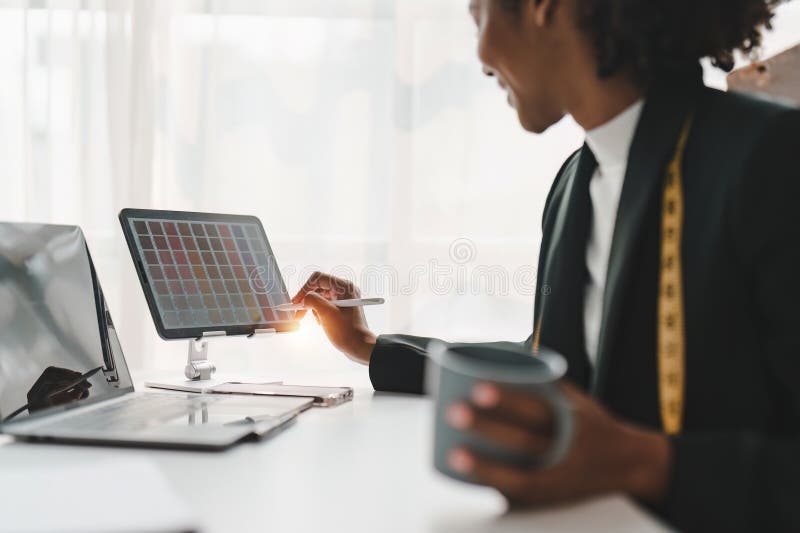 American African Fashion Designer Working in Studio with Laptop ...