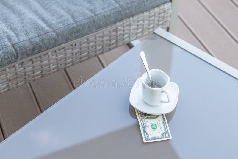 American Dollars Bill and Empty Cup of Coffee on a Glass Table of ...