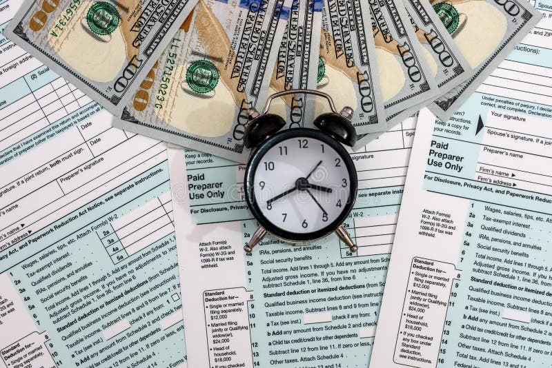 American Dollars with Clock Over Individual Tax Form Stock Photo ...