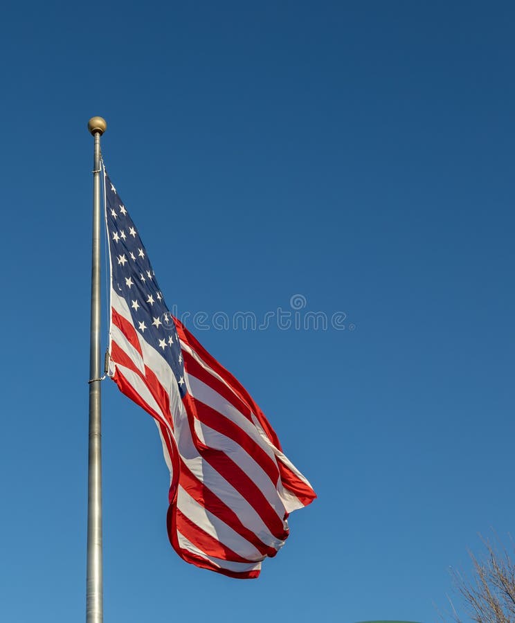 American Flag on Flagpole with Blue Sky Stock Photo - Image of ...