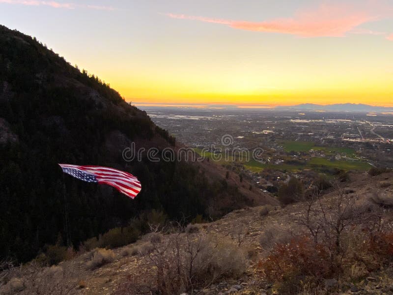 American Flag Flying in Canyon Over Valley at Sunset Stock Image ...