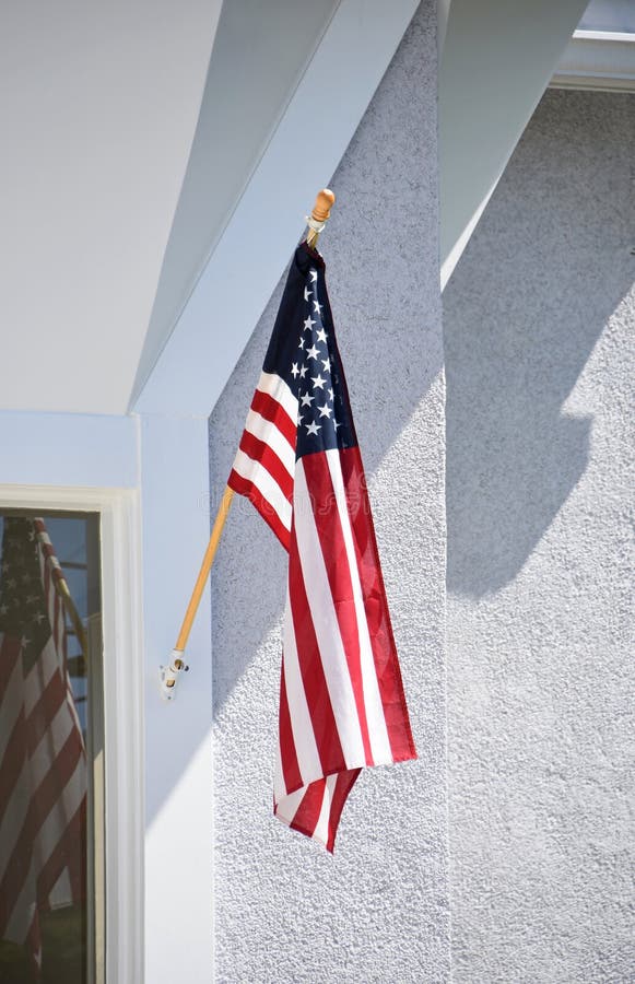 American Flag Hanging in Front of Entry Door Stock Photo - Image of ...