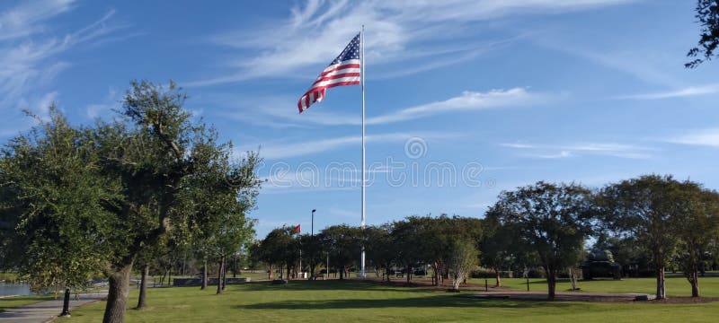 Flag of Louisiana Being Waved in the Breeze Against a Sunset Sky and ...