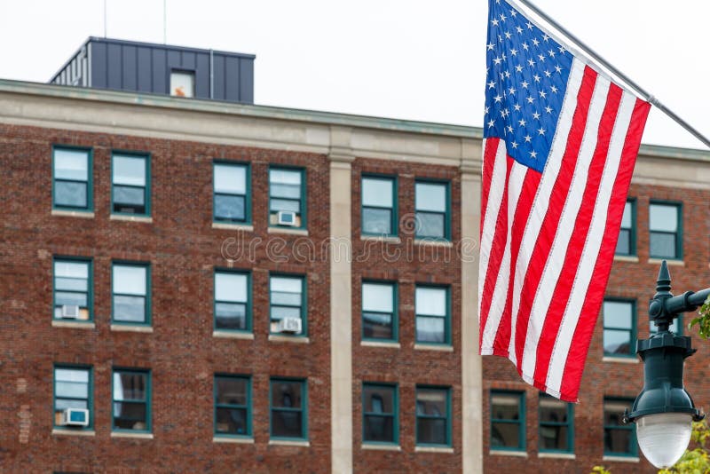 American Flag with Old Brick Building in Background Stock Photo - Image ...