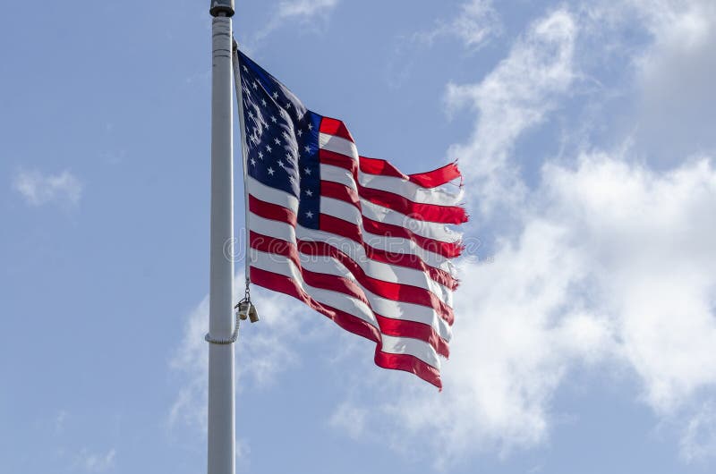 American Flag Snapping in Inconsistent Wind Stock Photo - Image of ...
