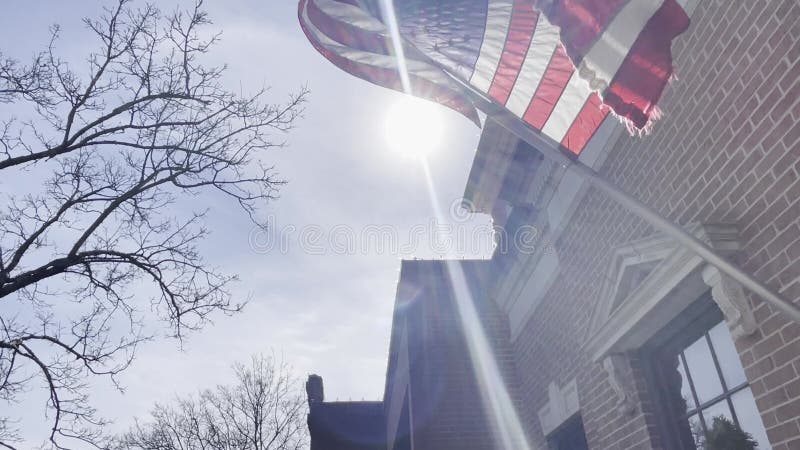 American Flag Waving in the Wind on a Building Small Town Usa Stock ...