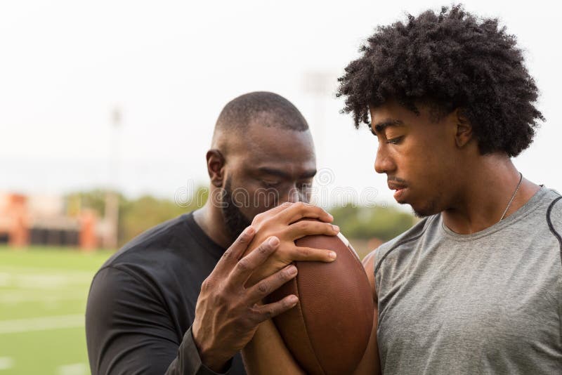 American Football Coach Training a Young Athlete. Stock Photo - Image ...