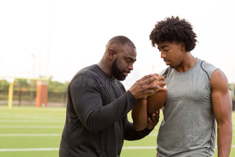 American Football Coach Training a Young Athlete. Stock Image - Image ...