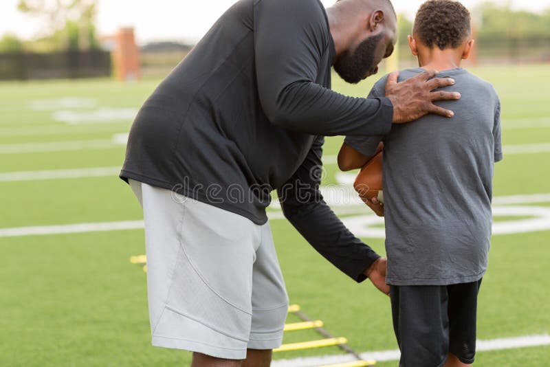 American Football Coach Training a Young Athlete. Stock Image - Image ...