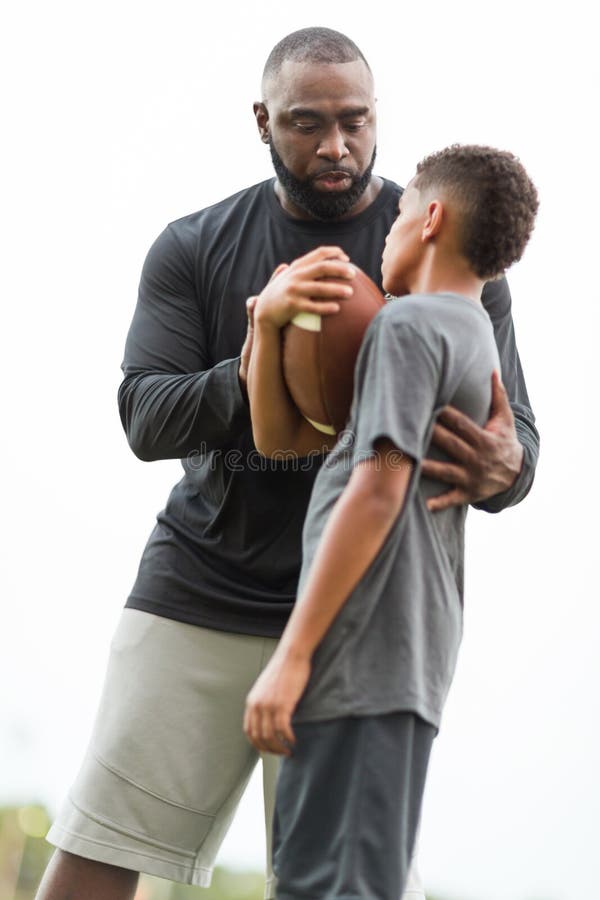 American Football Coach Training a Young Athlete. Stock Photo - Image ...