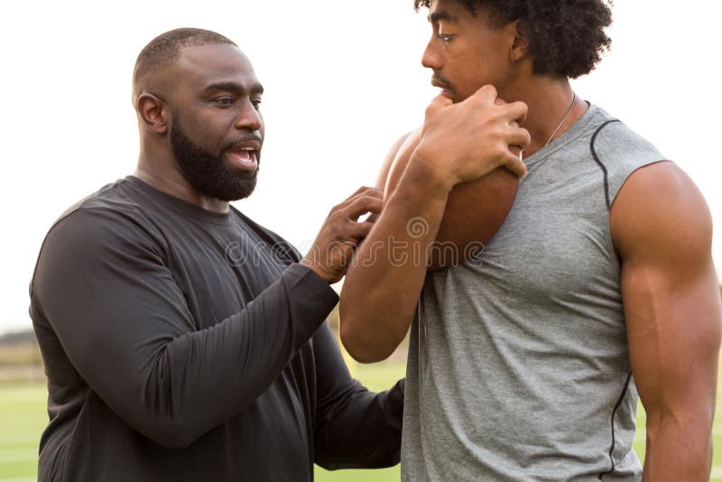 American Football Coach Training a Young Athlete. Stock Image - Image ...