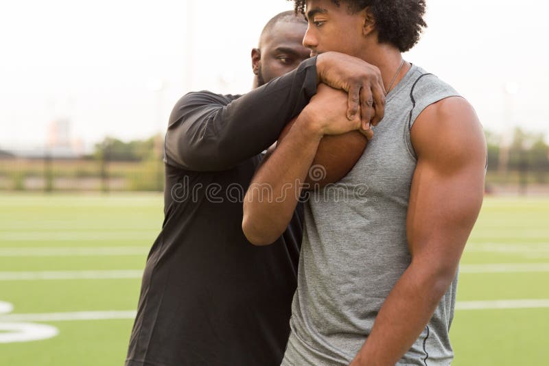 American Football Coach Training a Young Athlete. Stock Photo - Image ...