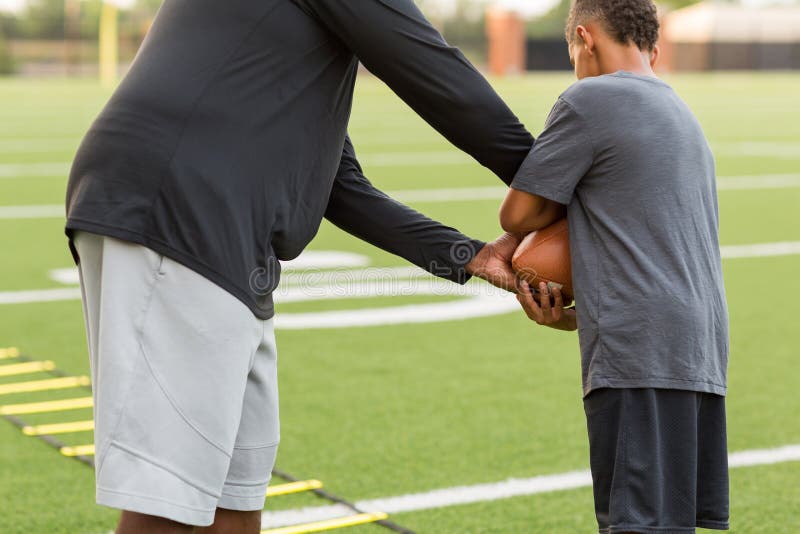 American Football Coach Training a Young Athlete. Stock Photo - Image ...