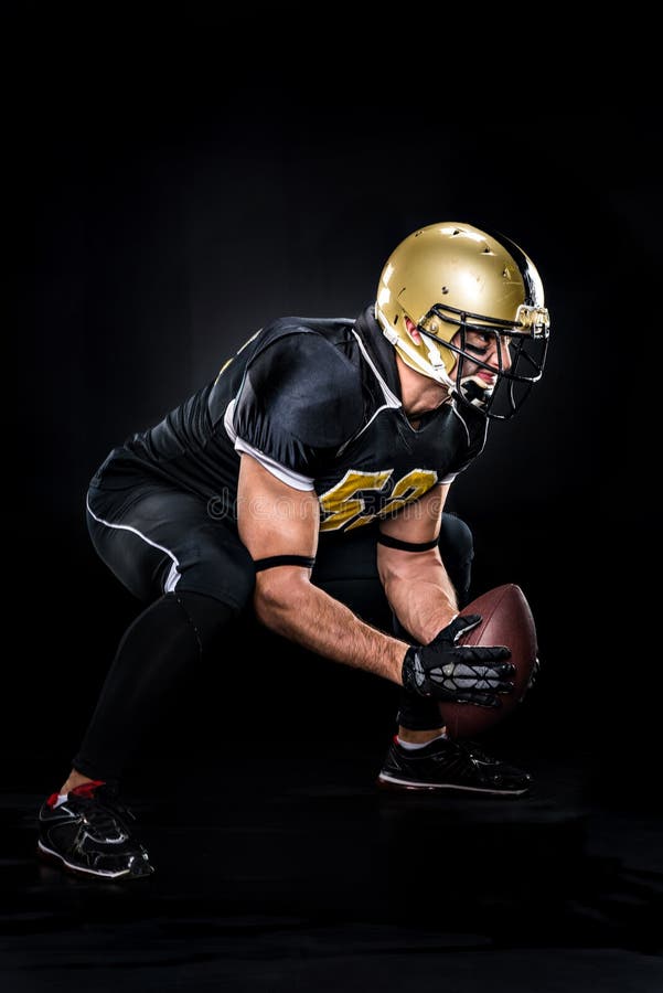 American Football Player Crouching Stock Photo - Image of dark, action ...