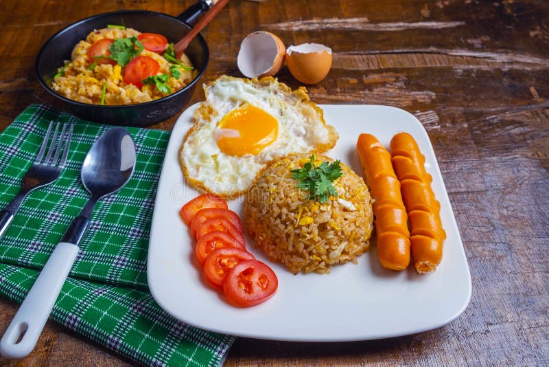 .American Fried Rice Served with Fried Eggs and Sausages on the Table ...