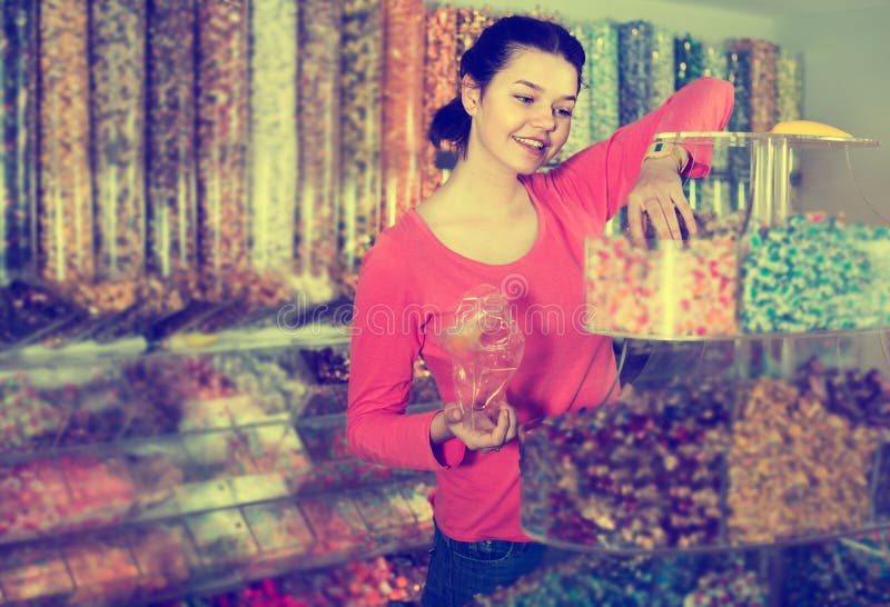 American Girl in Store is Picking Up Candies Stock Image - Image of ...